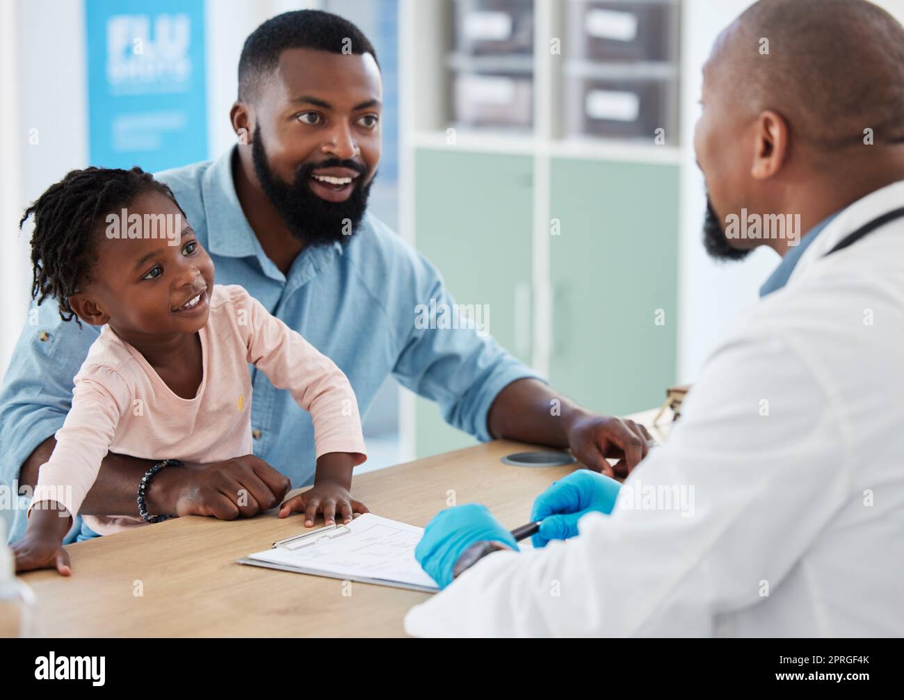 Pediatrician, child patient and doctor man talking to the father of a ...