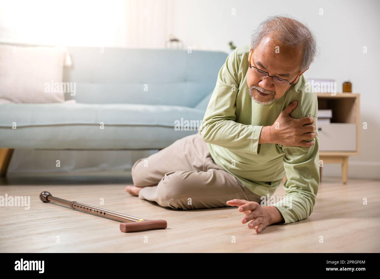 Sick senior old man falling down lying on floor because stumbled at ...