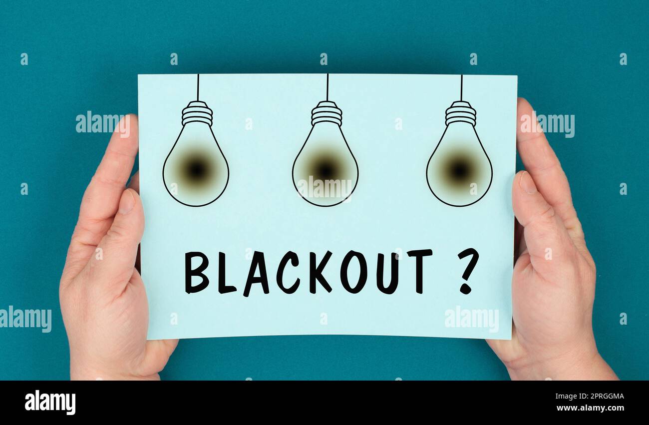 The word blackout is standing under the blown lightbulbs, power cut out ...