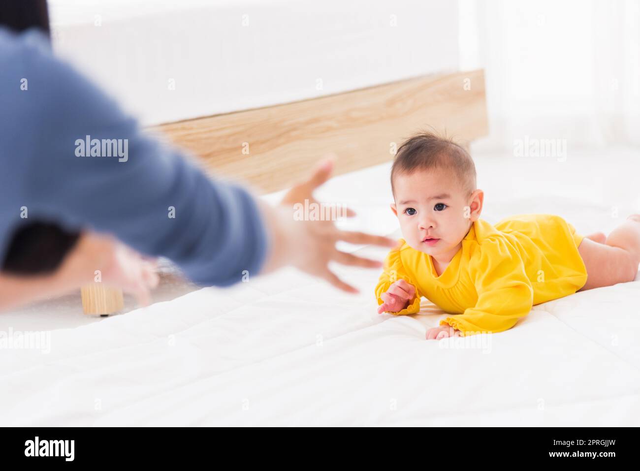 mother have fun learn walking crawling his daughter baby indoors ...