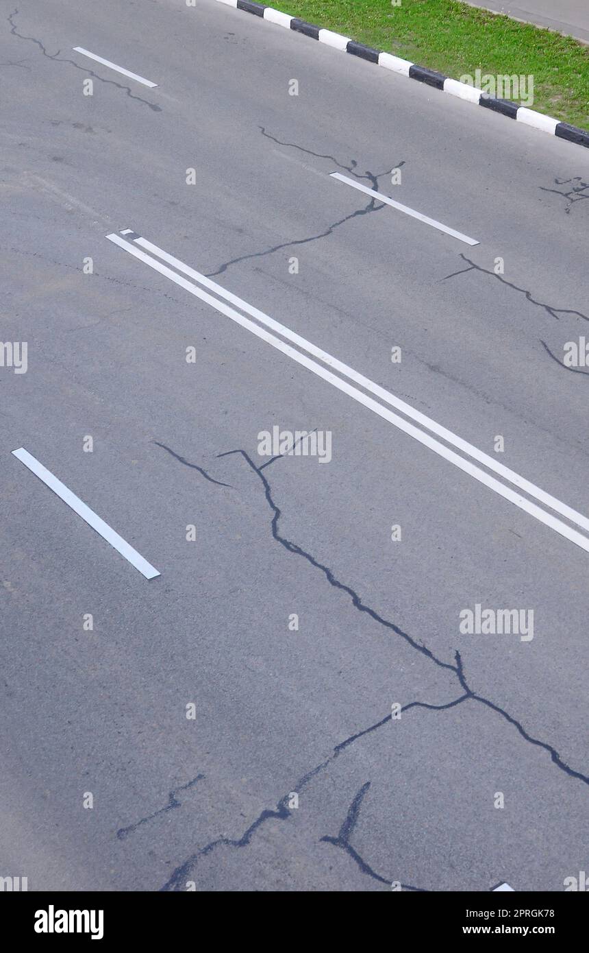 Damaged bad asphalt road with potholes. Patch repair of asphalt. Bad ...