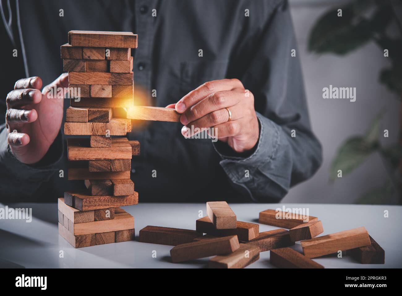 Alternative risk plan. Business hand playing tower wooden blocks game ...