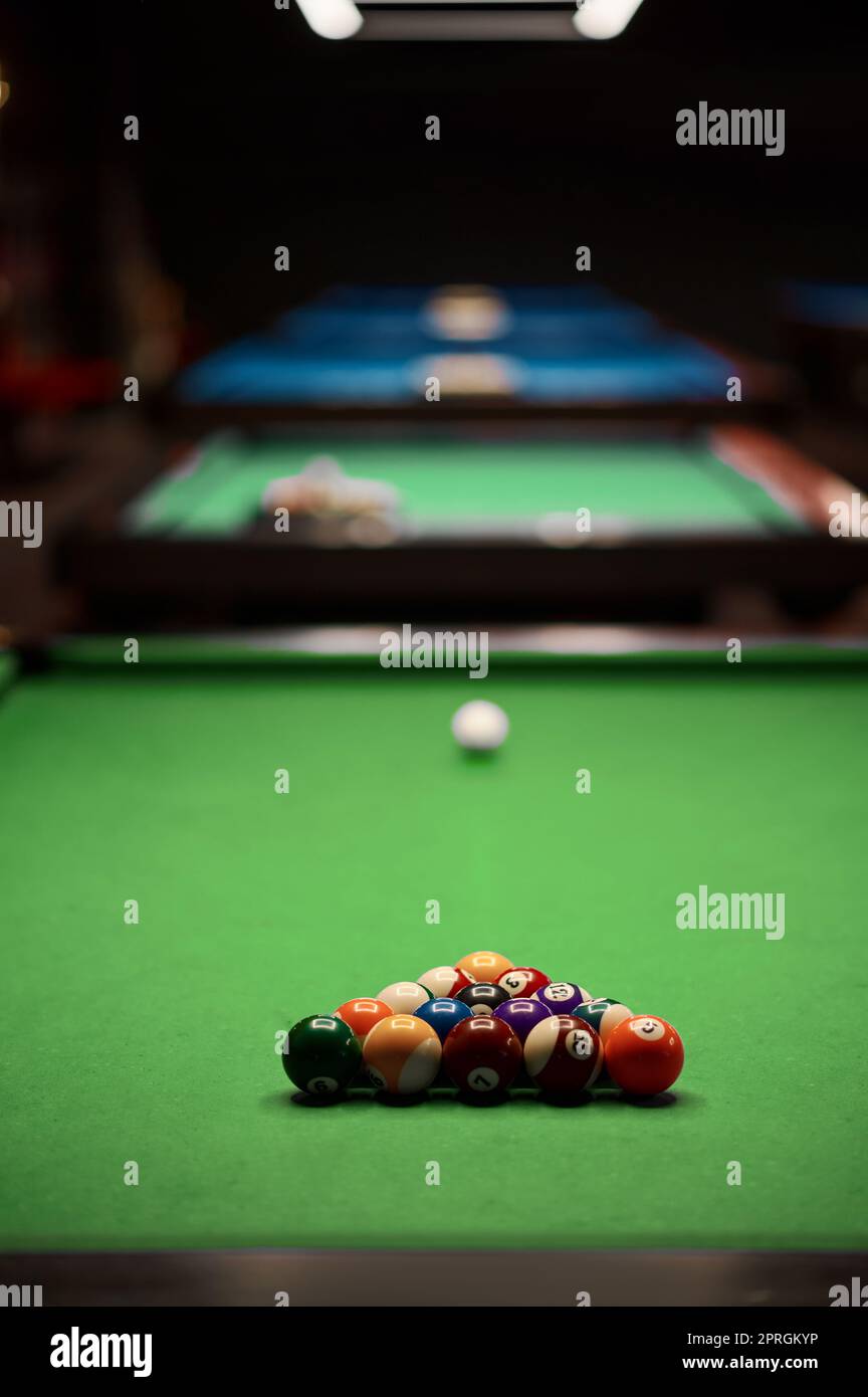 Billiard table with green surface and ball prepared for game, pool bar ...