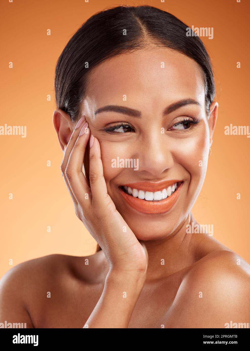 Makeup, skincare and woman with smile for cosmetics against an orange ...