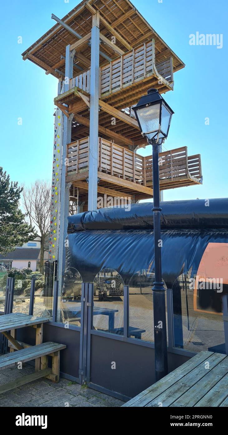 Large observation tower or climbing tower made of wood with a roof ...