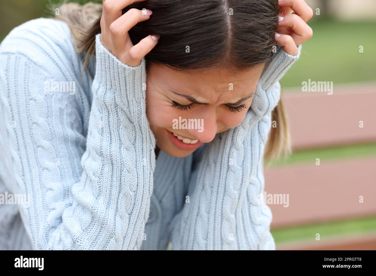 Desperate sad teen complaining alone sitting on a bench Stock Photo - Alamy