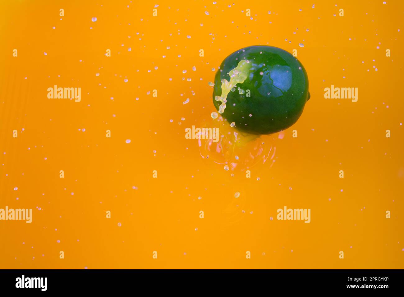 lime fruit splashing in orange juice organic natural drink splash Stock ...
