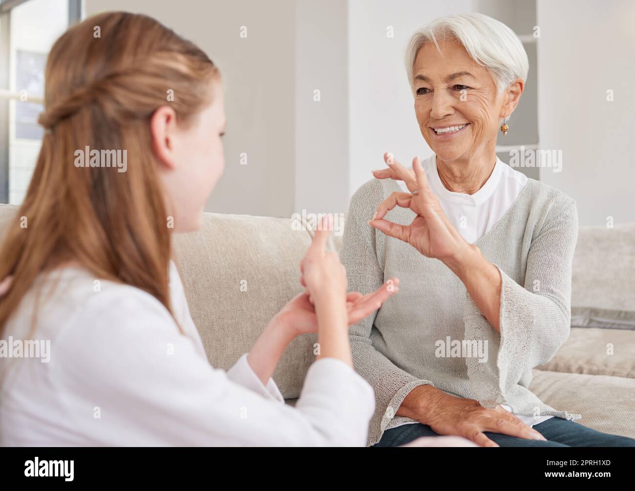 Senior woman, sign language and deaf girl communication, talking or ...