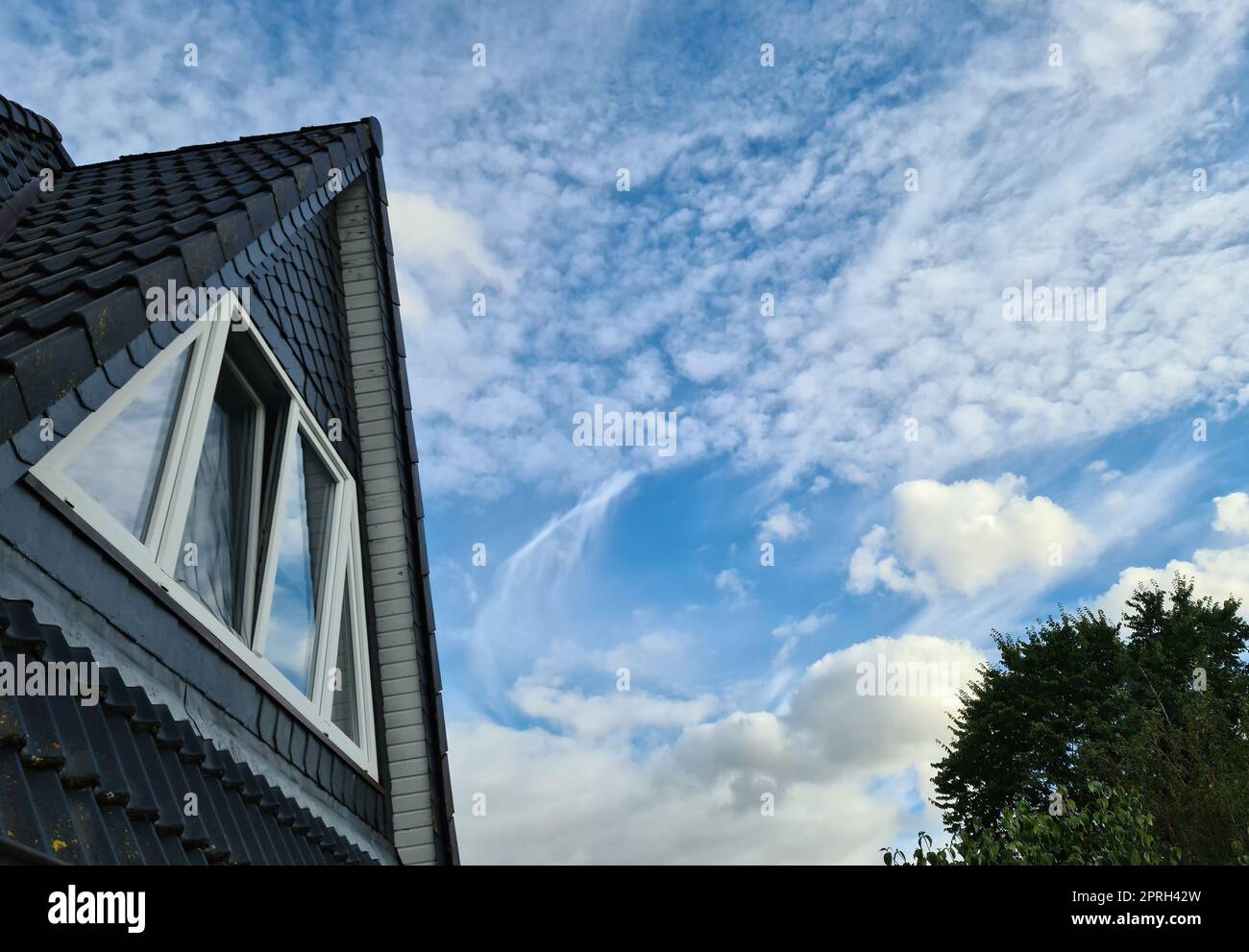 Open roof window in velux style with black roof tiles Stock Photo - Alamy