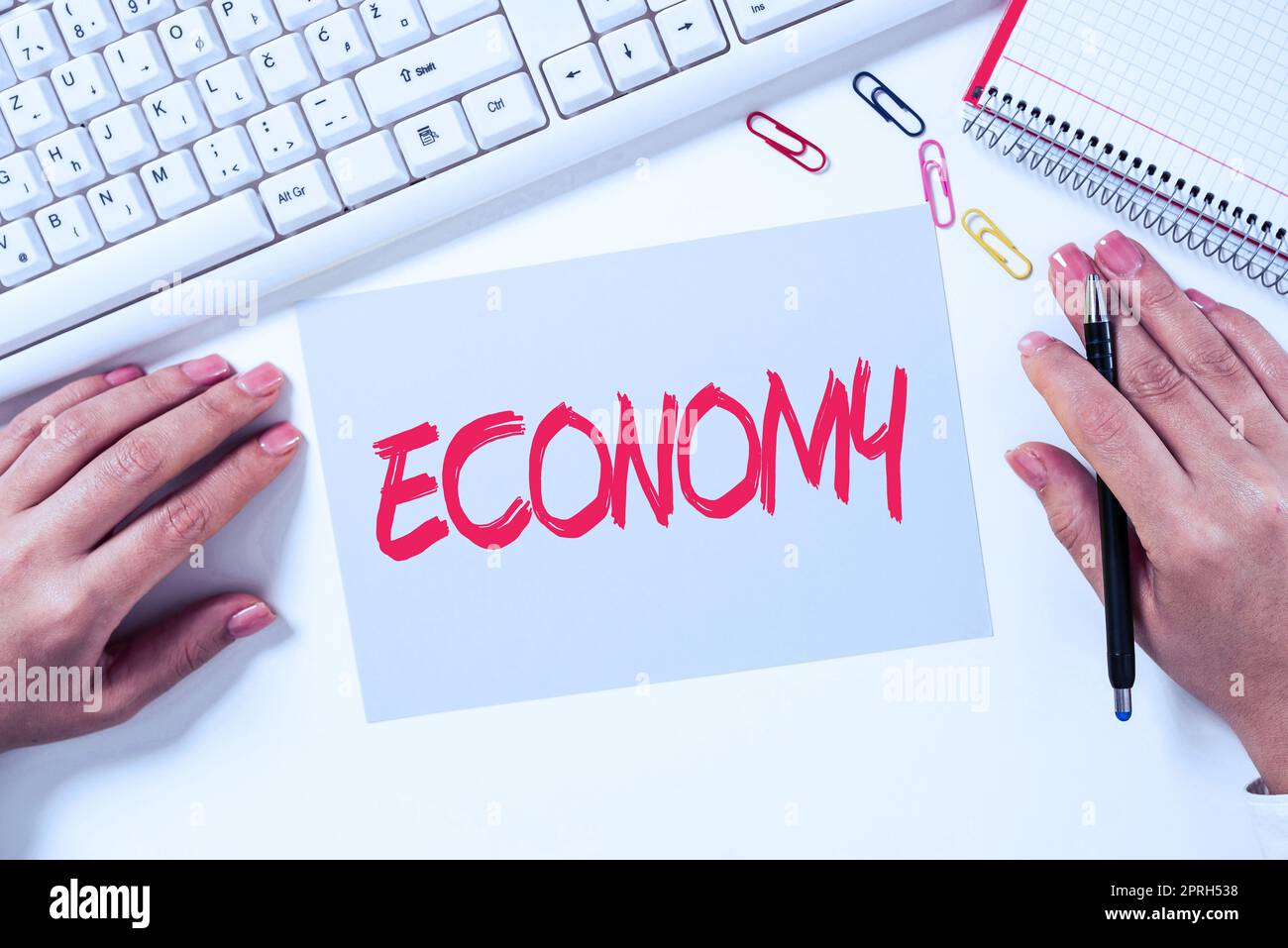 Hand writing sign Economy, Word Written on the system of how money is ...