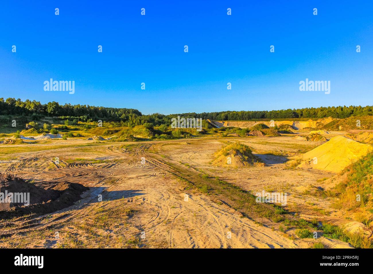 Excavated sand mountains and rubble piles quarry lake dredging pond Stock Photo - Alamy
