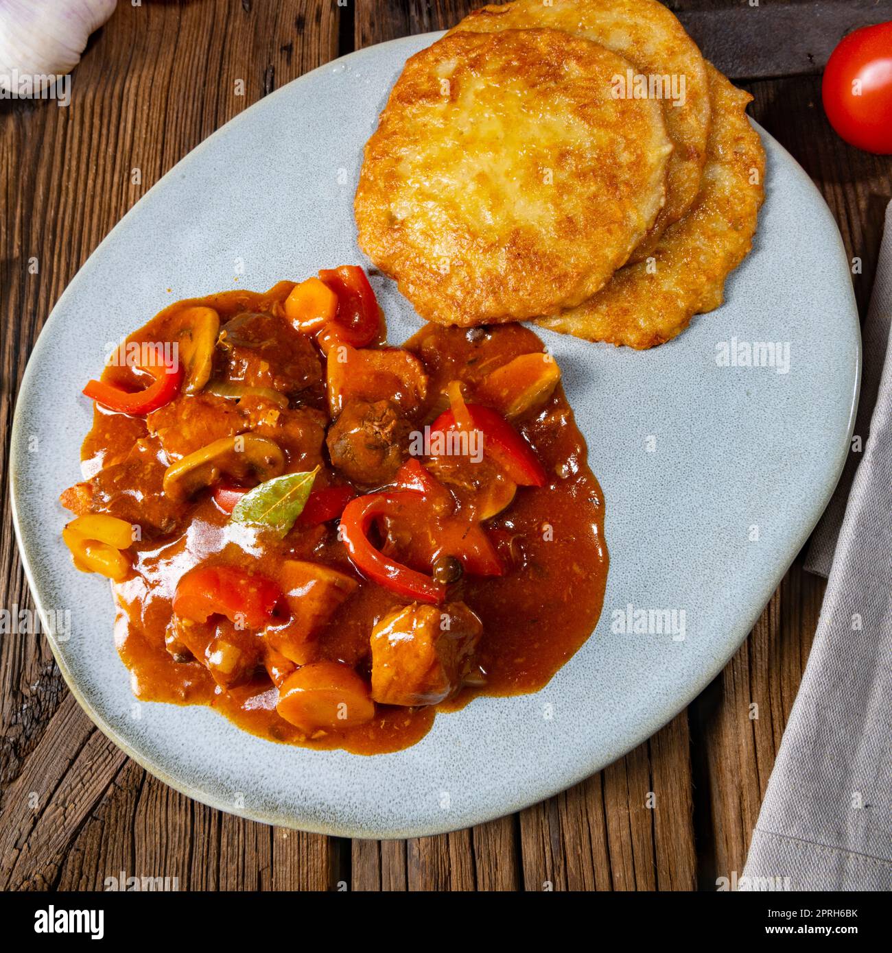 Hungarian goulash with potato pancakes Stock Photo - Alamy