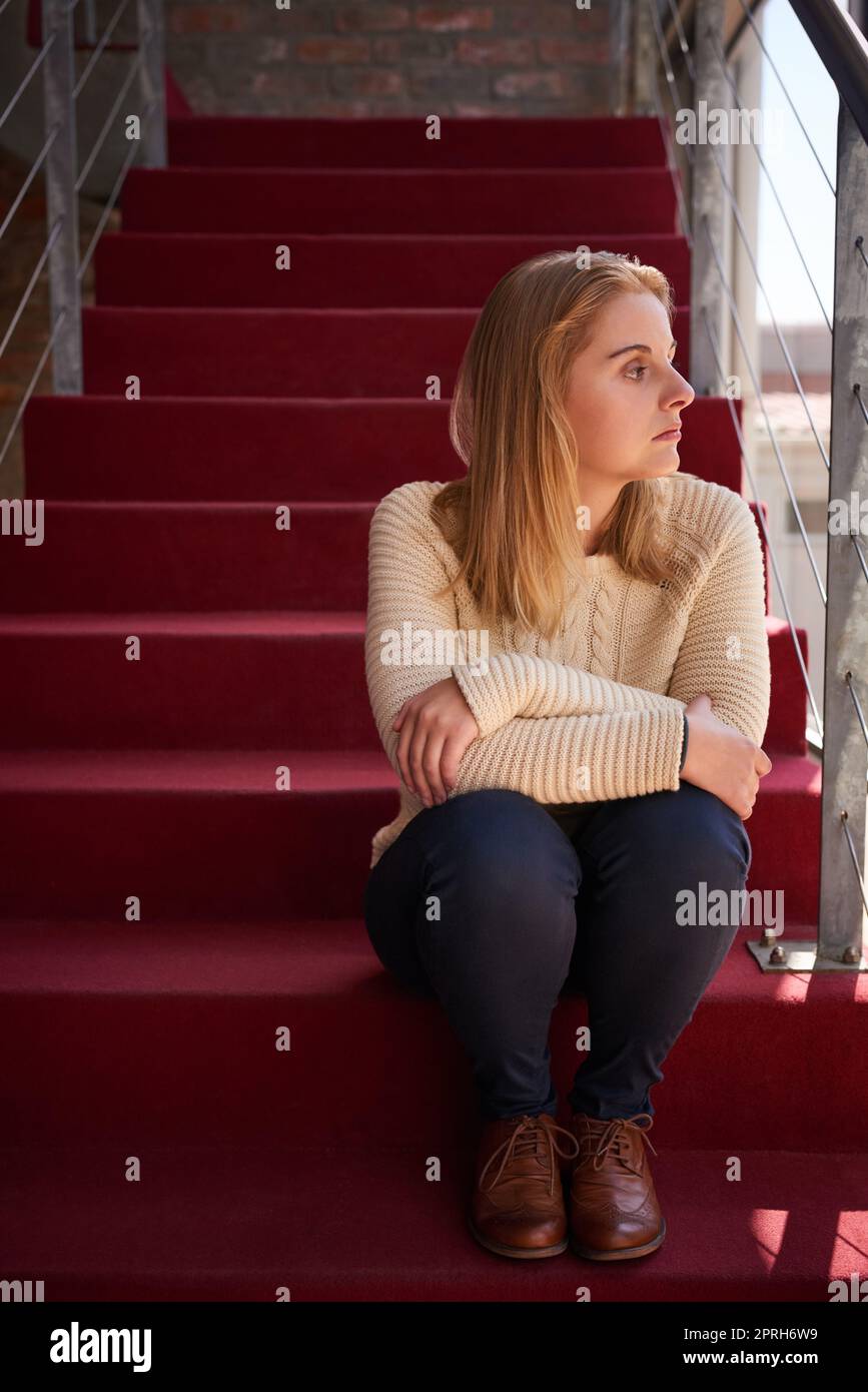 Campus life. a university student sitting on a staircase at campus ...
