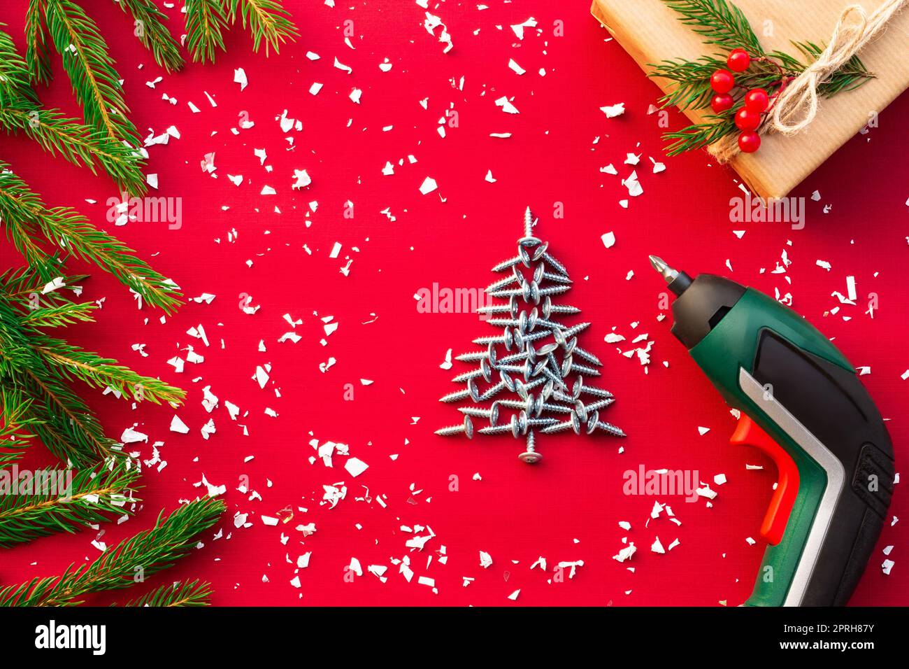 Christmas tree made of self-tapping screws, screwdriver, gift in craft ...
