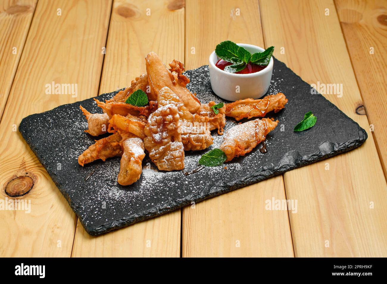 Deep fried fruits in breading served with caramel and strawberry jam ...