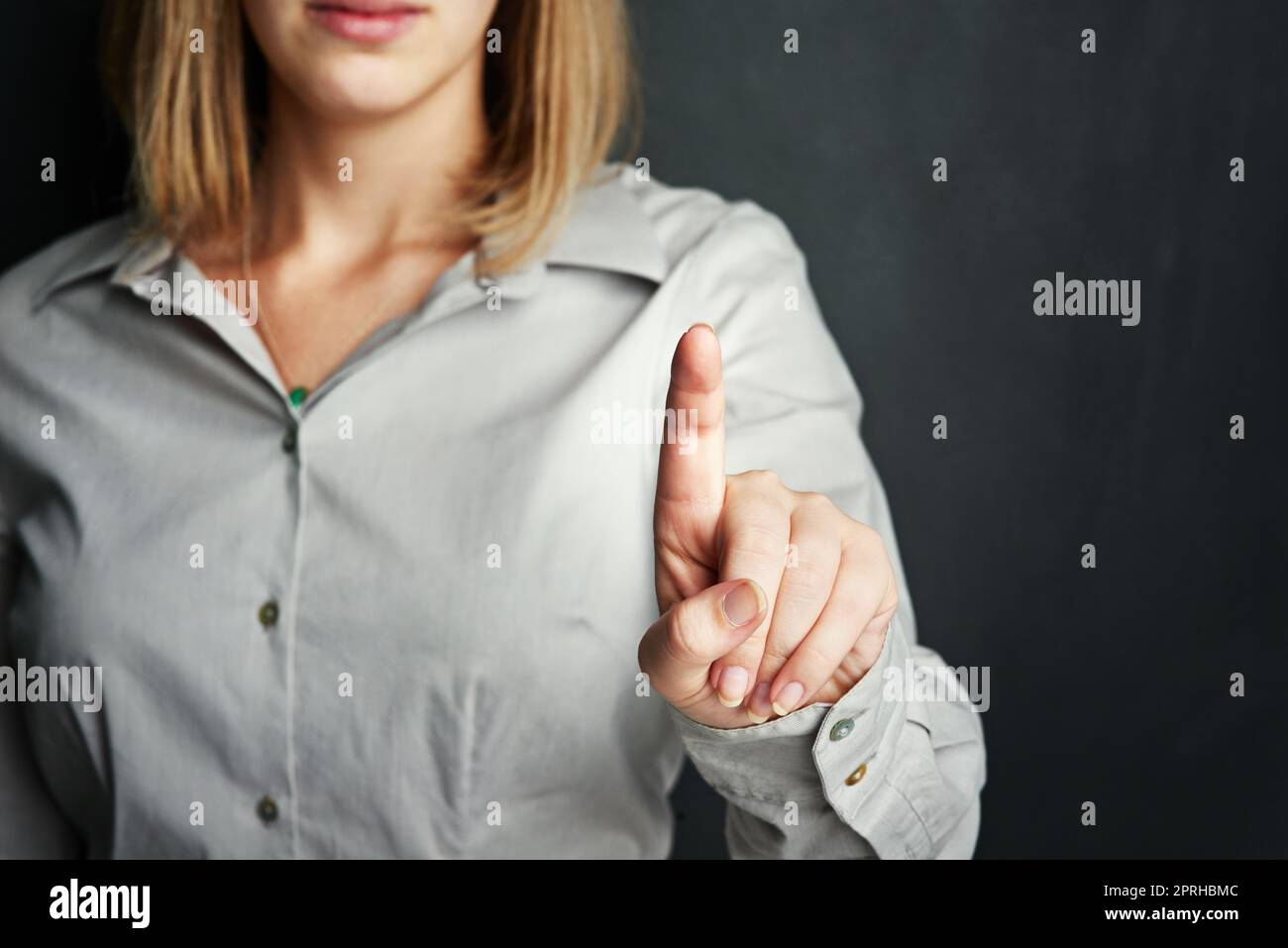 Touch the world of tomorrow. Studio shot of a woman connecting to a ...