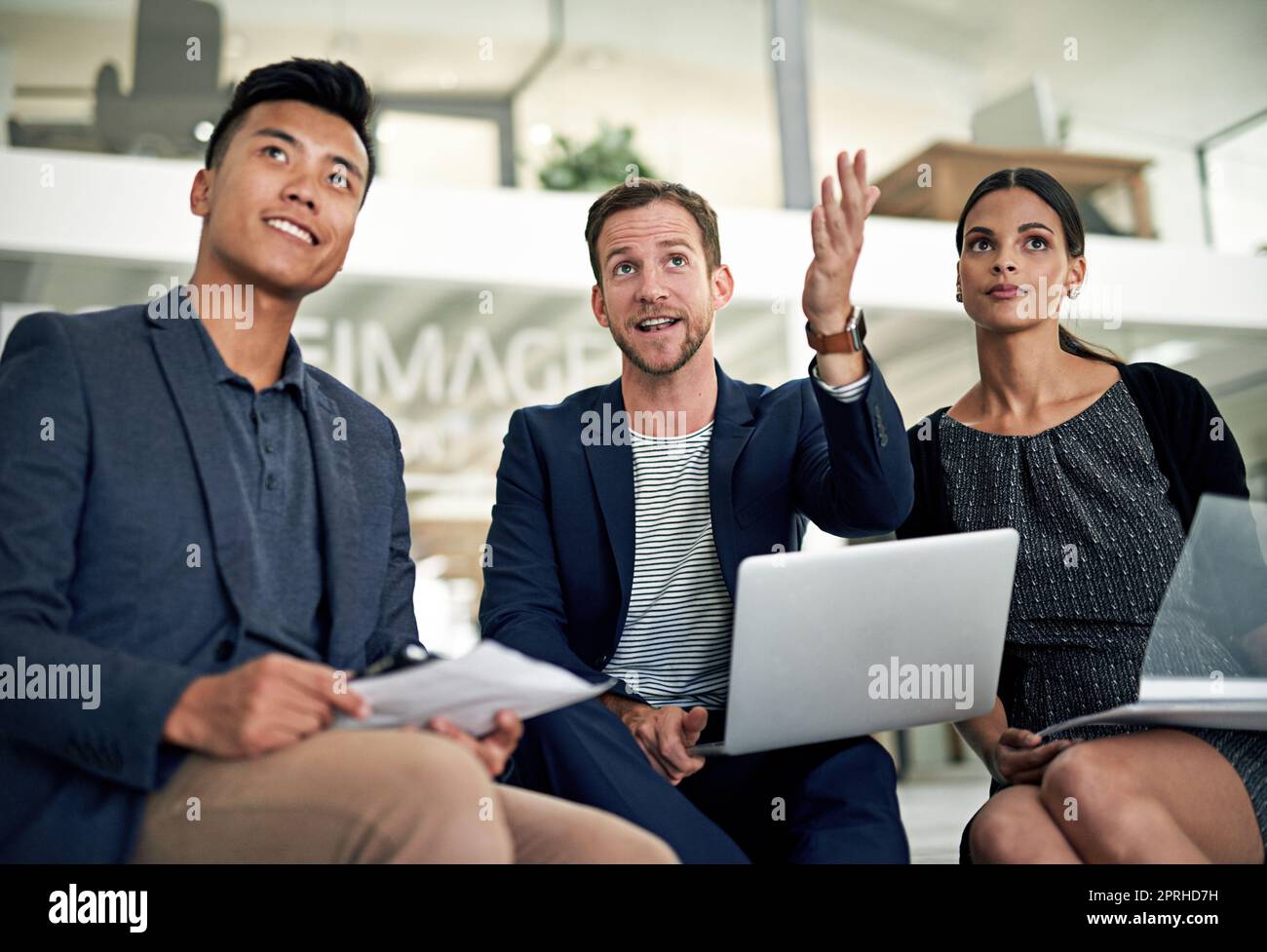 Our future is bright. three colleagues working in the office Stock ...