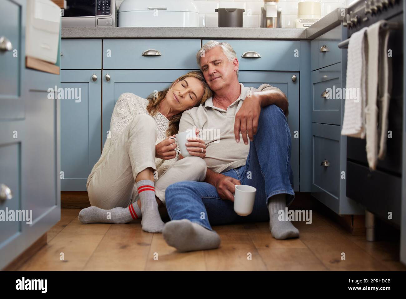 Senior couple, love and support while sitting together feeling safe ...