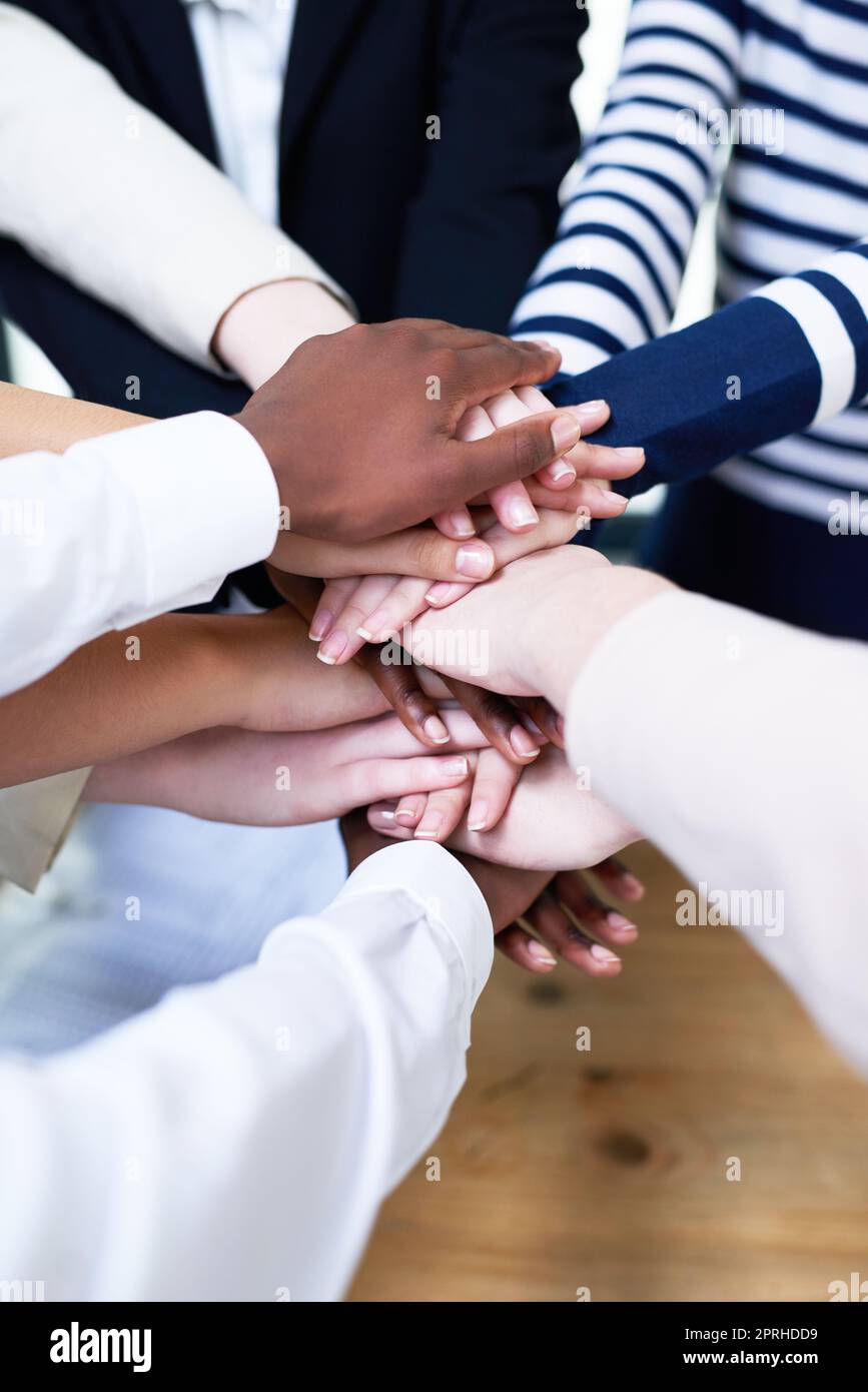 And...break. High angle shot of a group of colleagues standing with ...
