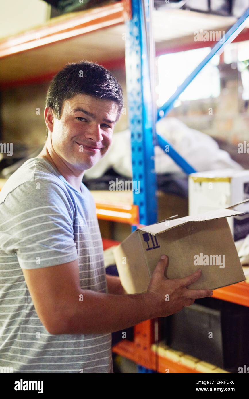 Clearing out and cleaning up. Portrait of a man carrying a box in a ...