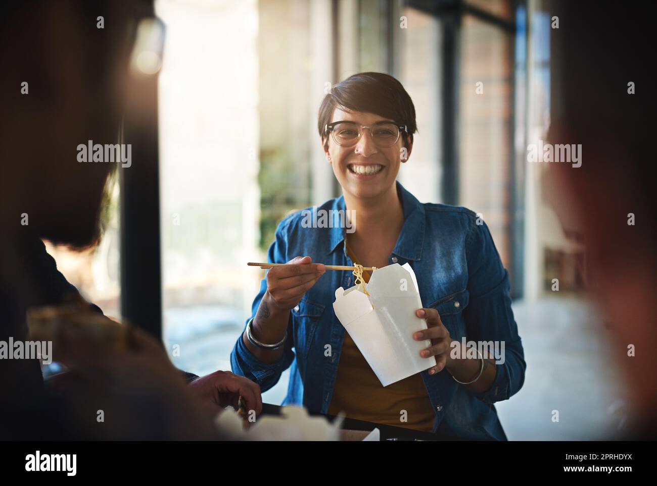 Food is the key to a great meeting. a group of colleagues eating while ...