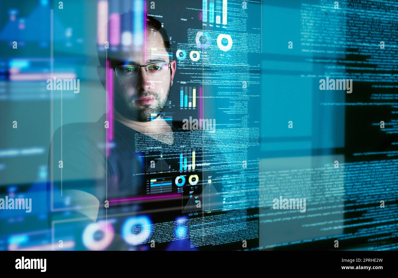 Going through endless data streams. a young computer programmer looking through data Stock Photo ...