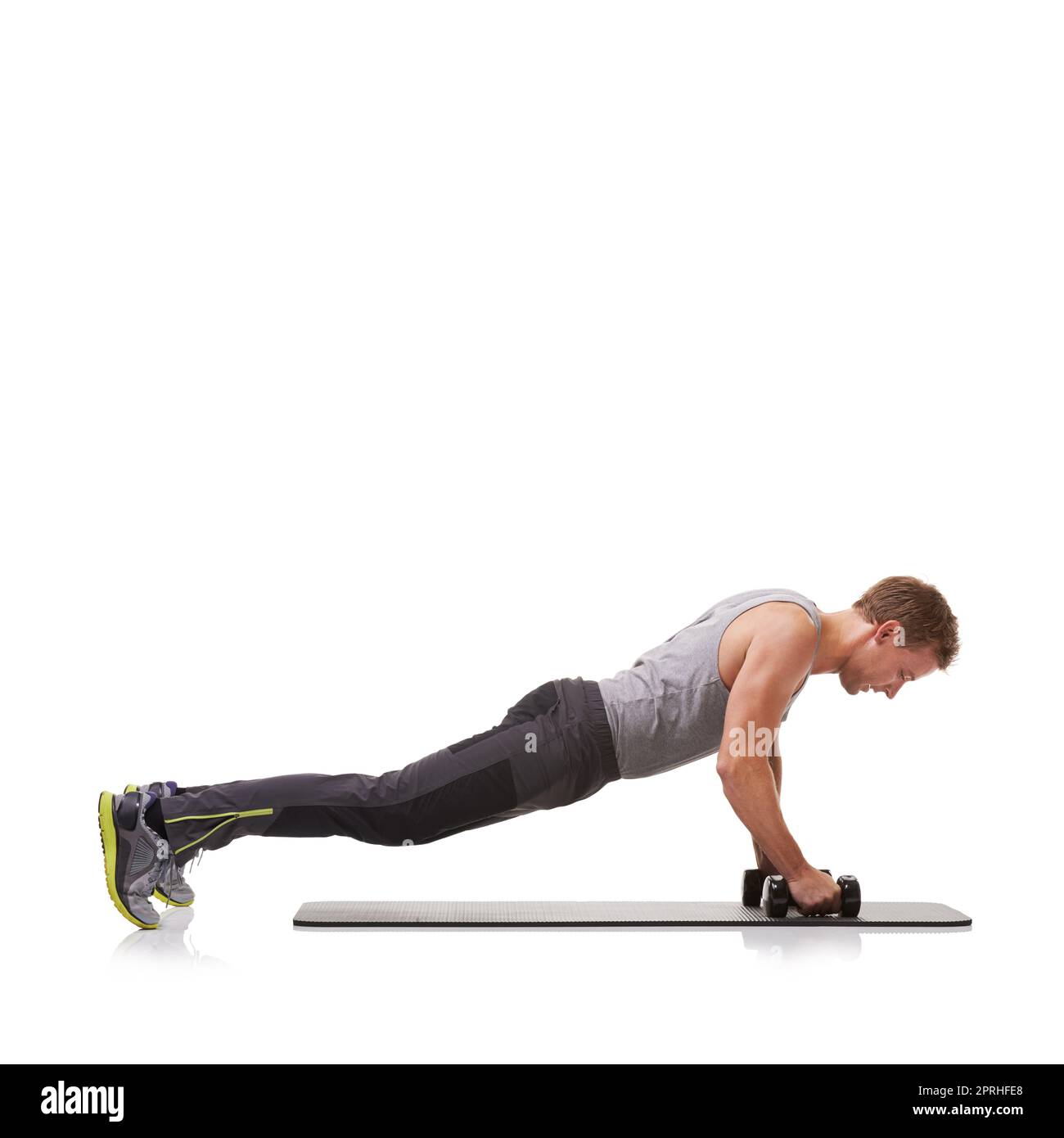 Toning his chest muscles. A fit young man doing push-ups with a pair of ...