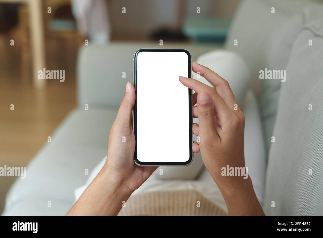 close-up hand using phone showing white screen in living room Stock ...