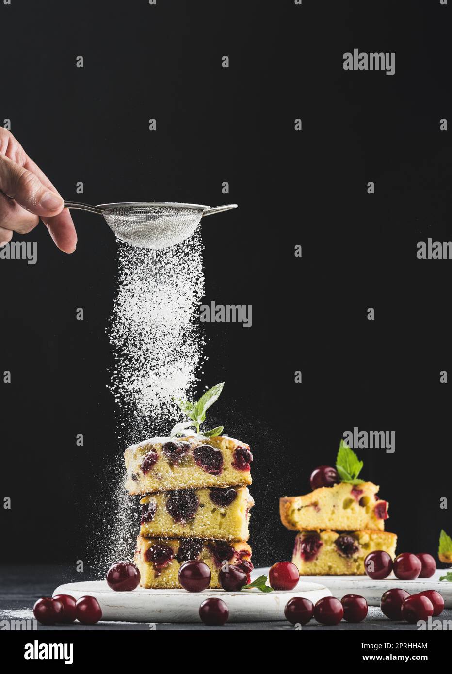 Baked sponge cake with cherries sprinkled with powdered sugar Stock ...