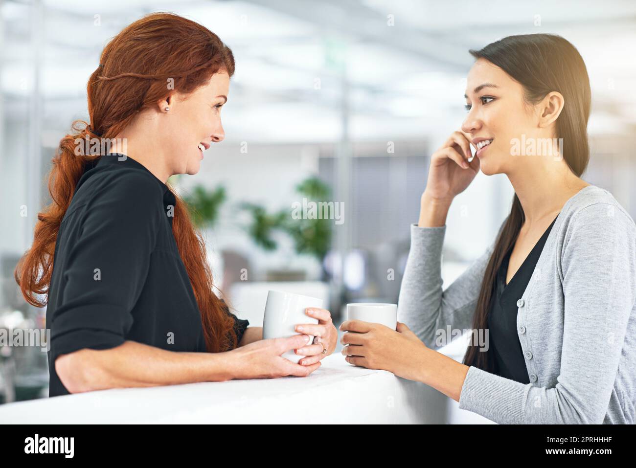 Its important to get along in the workplace. two businesswomen having a ...