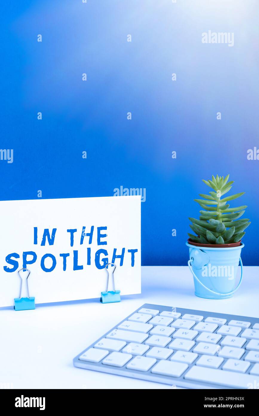 Sign displaying In The Spotlightwhen crowd concentrating with ...