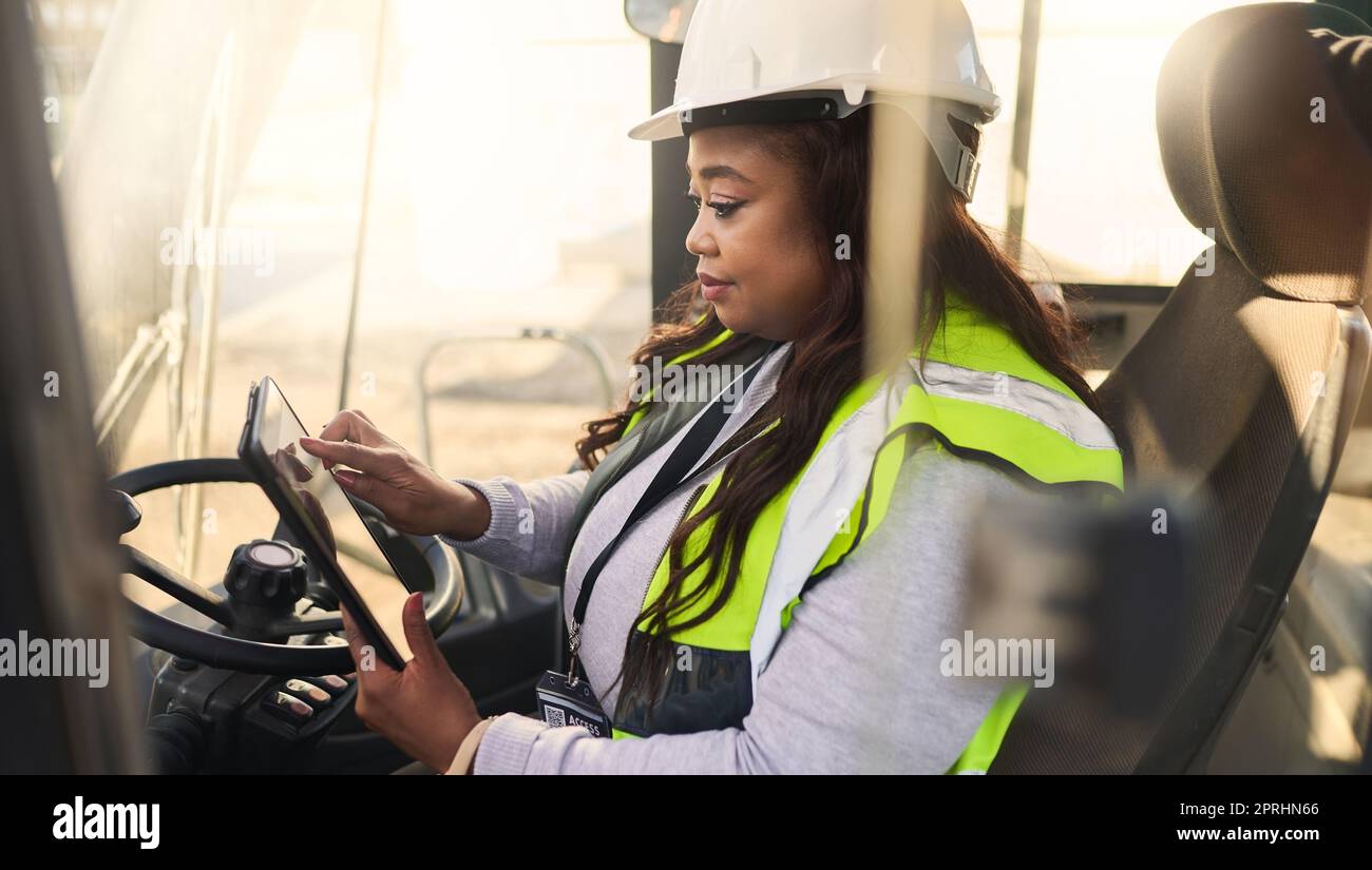 Logistics, tablet and black woman in crane in shipping plant ...
