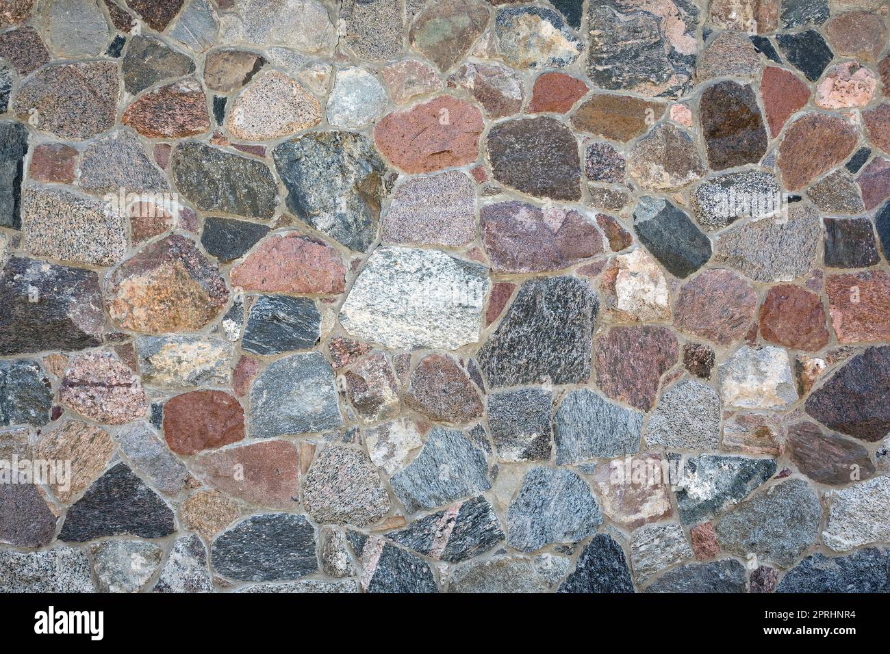 Stone wall with different colors and size of rocks Stock Photo - Alamy