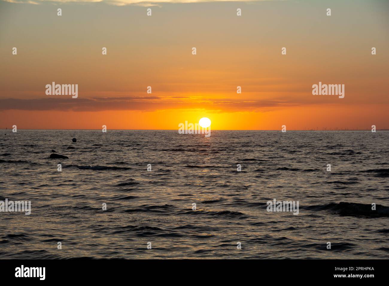 The sun on the horizon, setting over the sea Stock Photo - Alamy