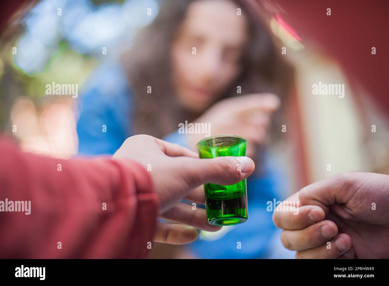 Very drunk couple, a boy and a girl, drink a strong alcoholic shot ...