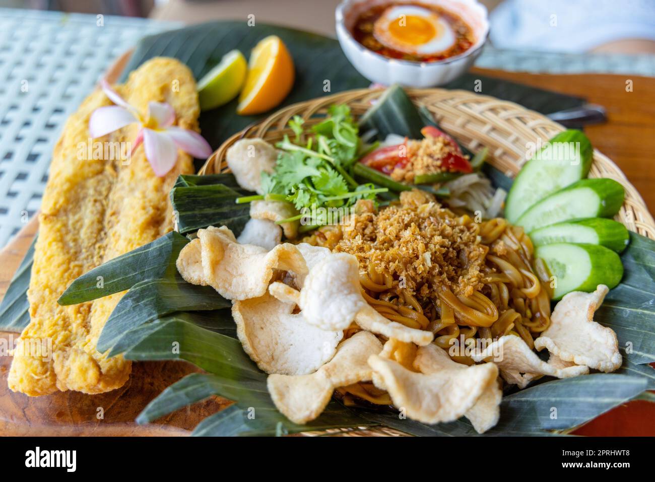 Thai cuisine, crispy fish fillet and pad thai Stock Photo - Alamy