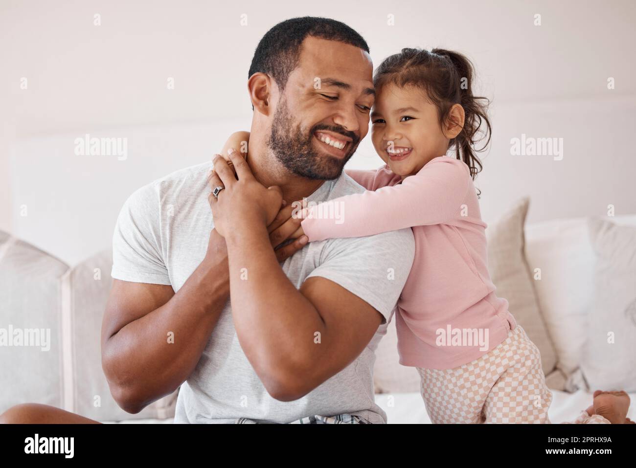 Love, father and family morning hug in bedroom together with child for joyful parent bond in ...