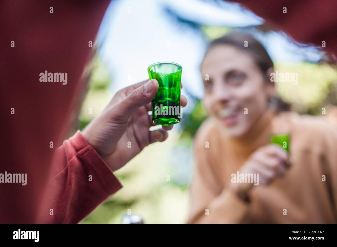 Very drunk couple, a boy and a girl, drink a strong alcoholic shot ...