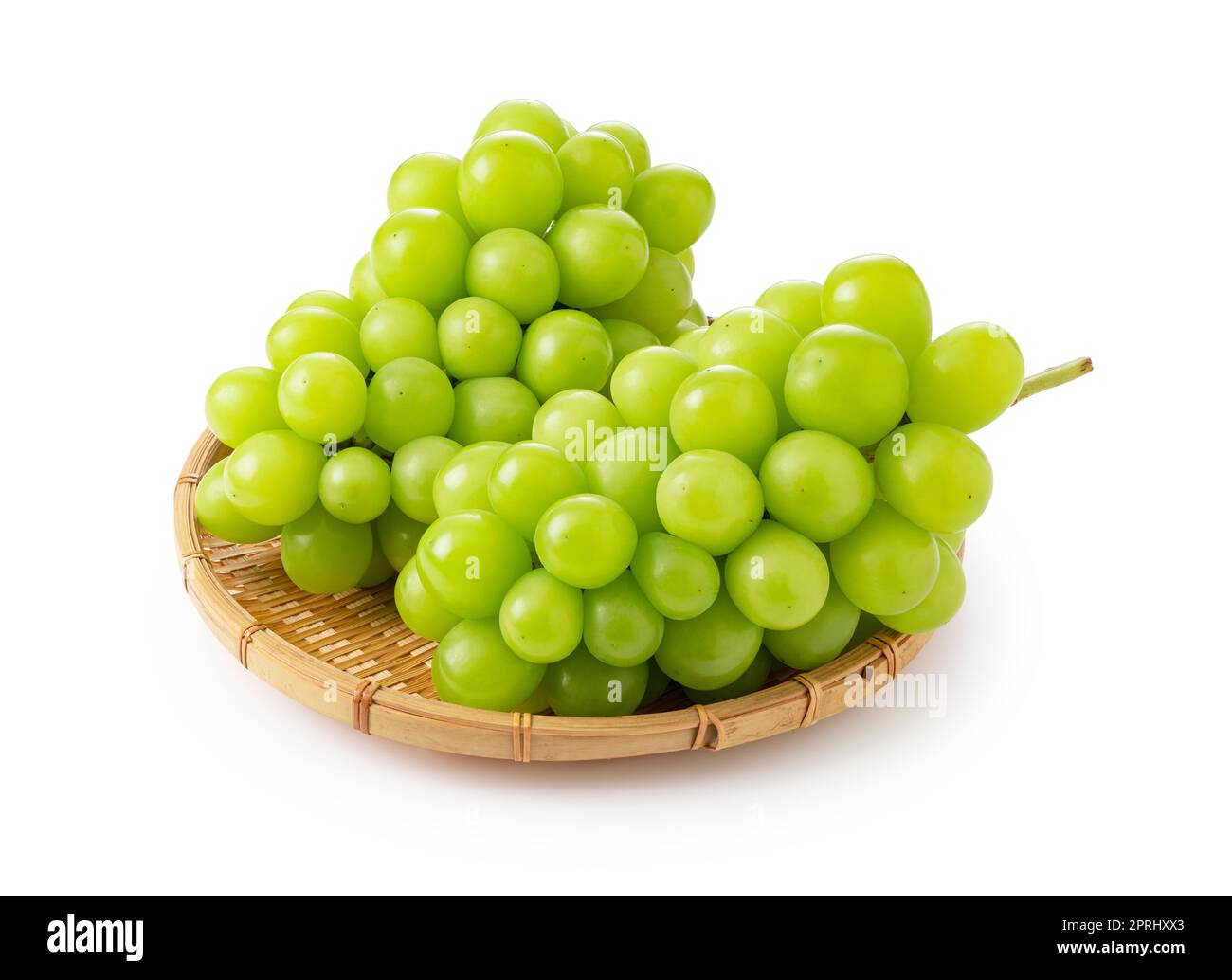 Shine Muscat in a bamboo colander on a white background. White grapes ...