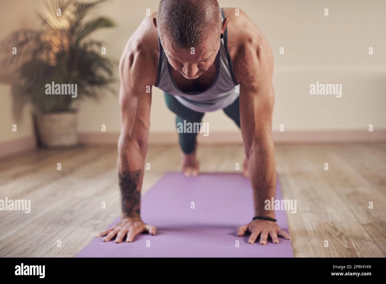 Building muscle strength. a handsome young man holding a high plank ...