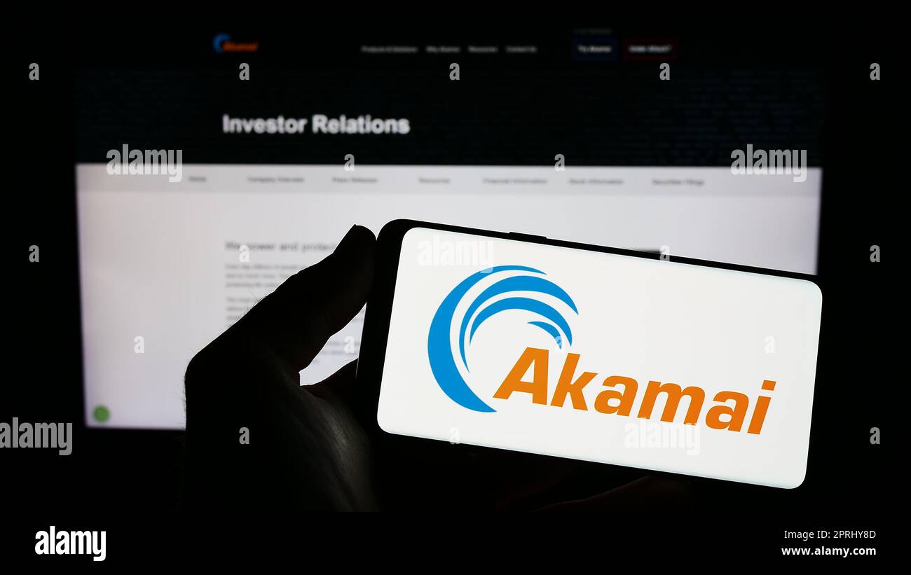 Person holding mobile phone with logo of American company Akamai ...