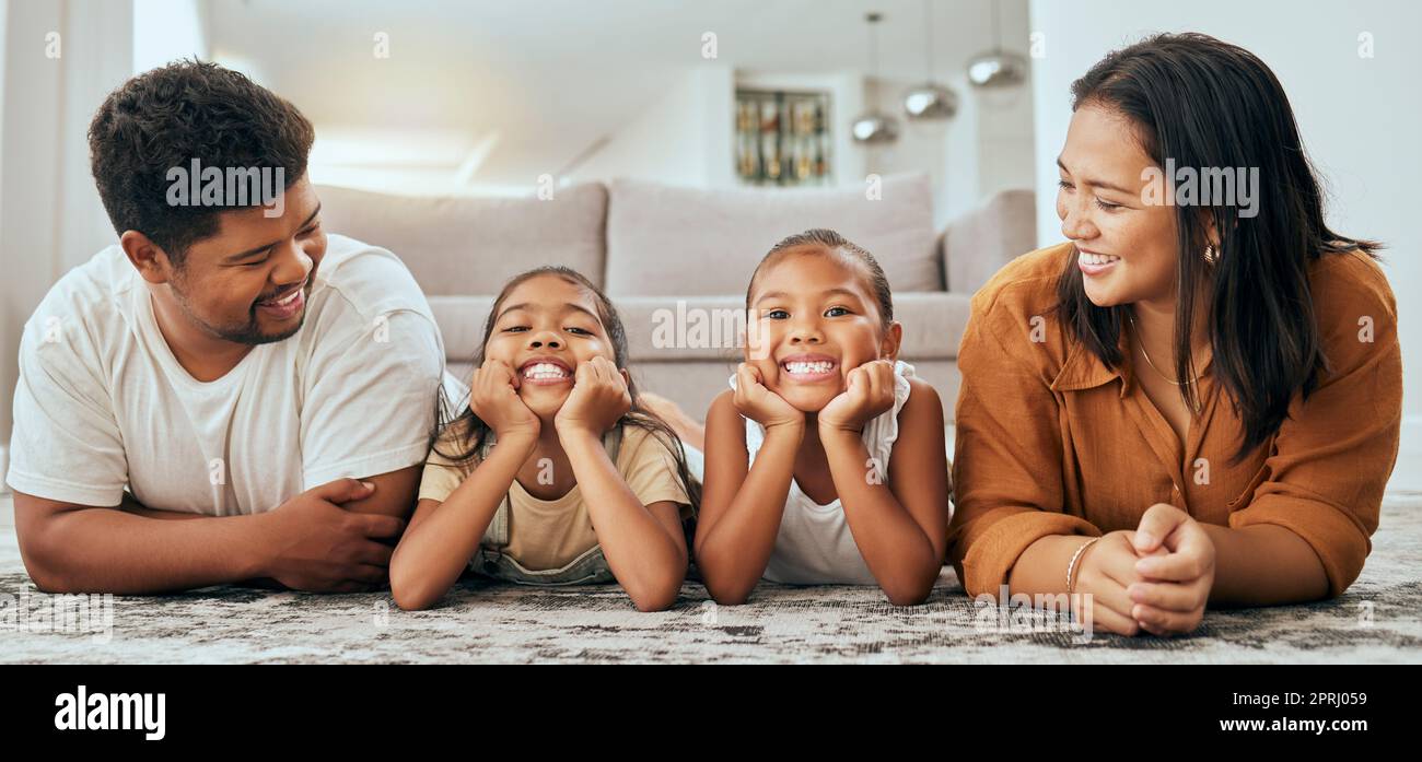 Love, happy family and lying relax on floor together in living room at ...