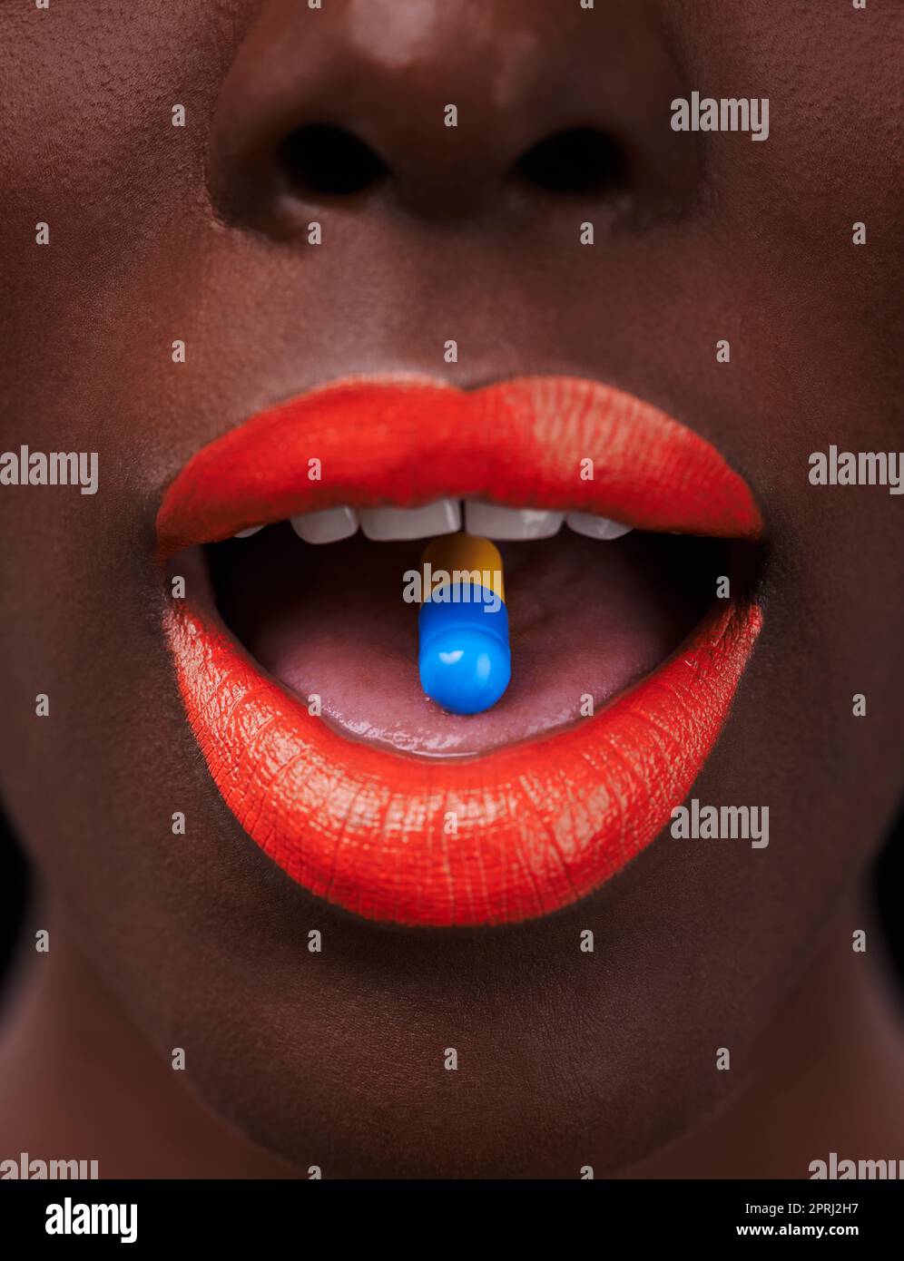 Woman taking pill red lips hi-res stock photography and images - Alamy