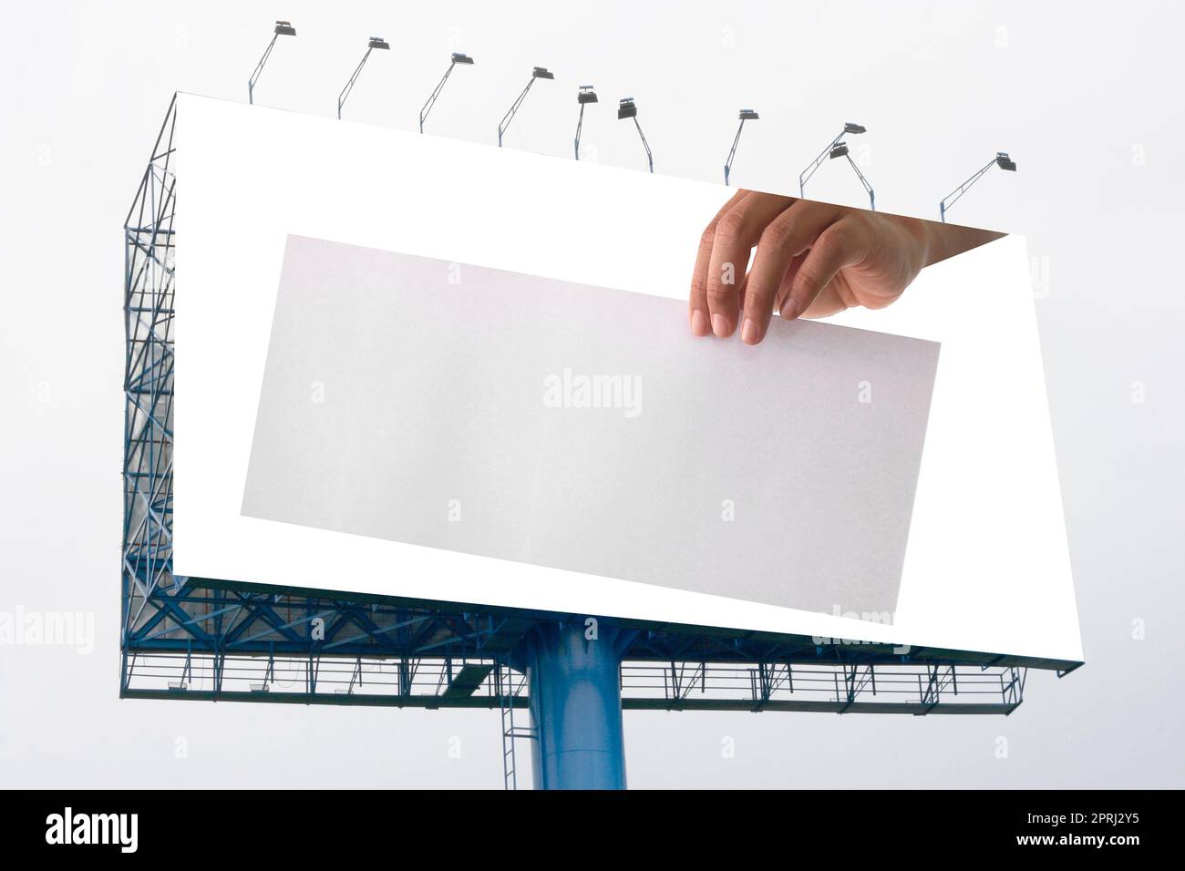 Advertising: Hand holding white empty paper on big billboard Stock ...