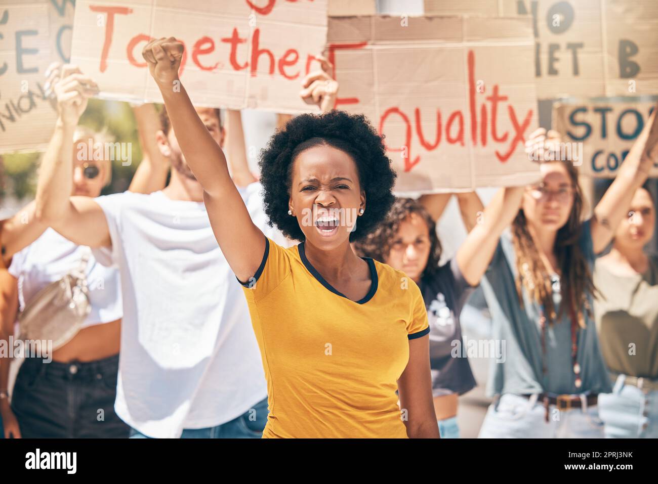 Protest, crowd of people and black woman in the street, fist in air ...