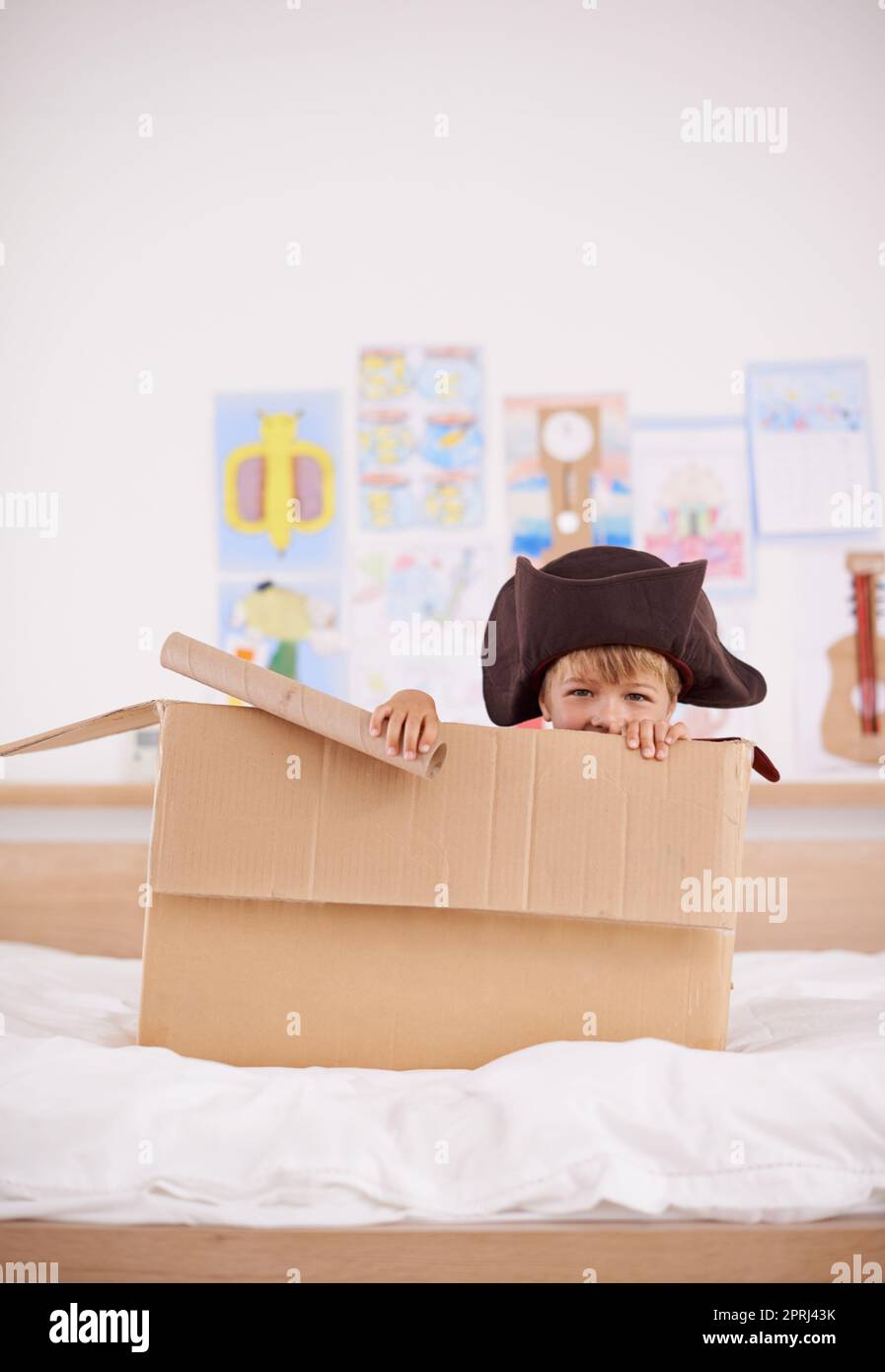 The piratical power of imagination. Portrait of a little pirate hiding ...