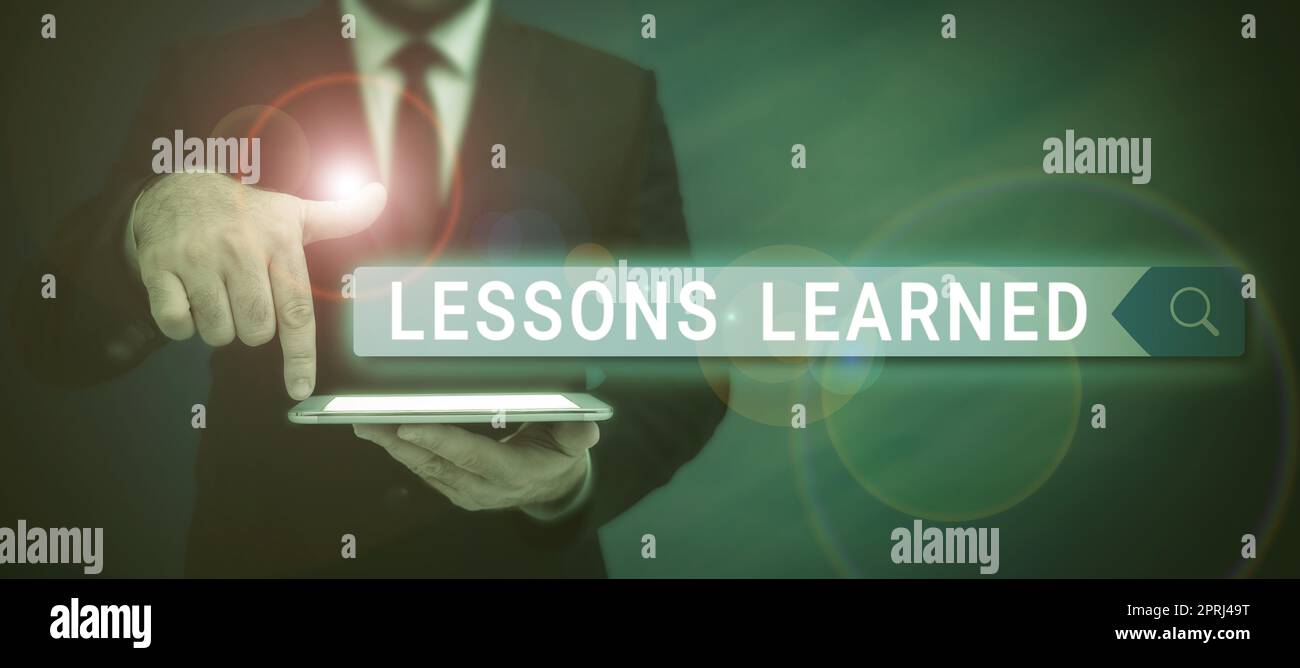 Hand writing sign Lessons Learned, Word Written on experiences garnered from understanding the ...