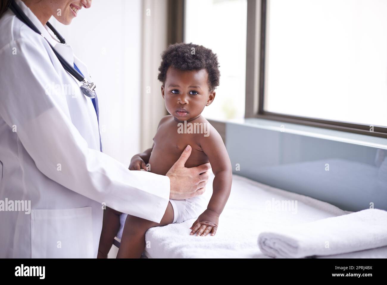 Just in for a routine pediatric checkup. a female pediatrician doing a ...