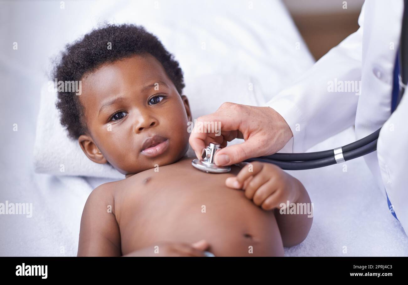 Just in for a routine pediatric checkup. a female pediatrician doing a ...