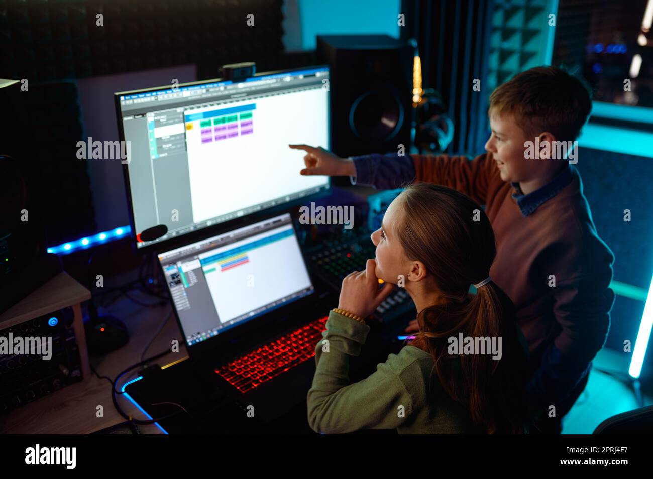 Overhead view on children musician mixing soundtrack melody on computer ...